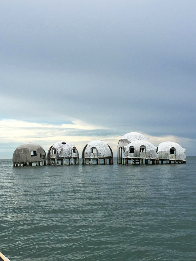 Under moody skies, the six remaining domes take on an almost melancholy beauty, like ancient ruins from a civilization that dreamed of living with the sea.
