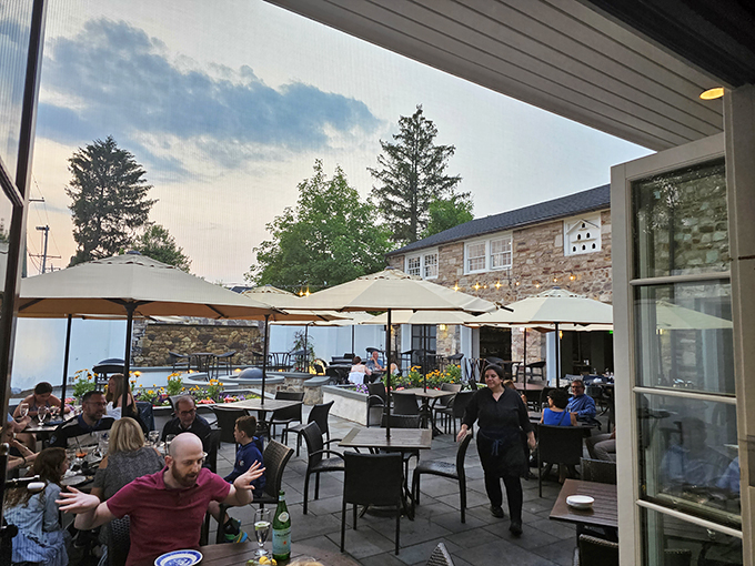 As evening approaches, the outdoor dining area transforms into a gathering place where food, friends, and fresh air create perfect harmony.