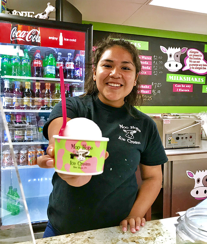 The joy on this server's face says it all&mdash;she's not just handing you ice cream, she's delivering a moment of pure happiness.