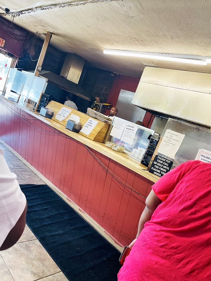 Behind this counter, barbecue magic happens daily. The staff doesn't need fancy uniforms when they're wearing the confidence of smoke masters.