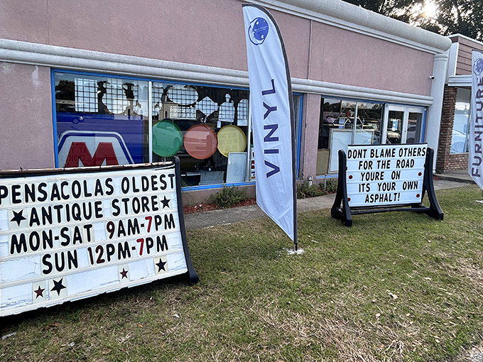 The sign says it all: Pensacola's oldest antique store dispenses both shopping hours and roadside philosophy with equal conviction.