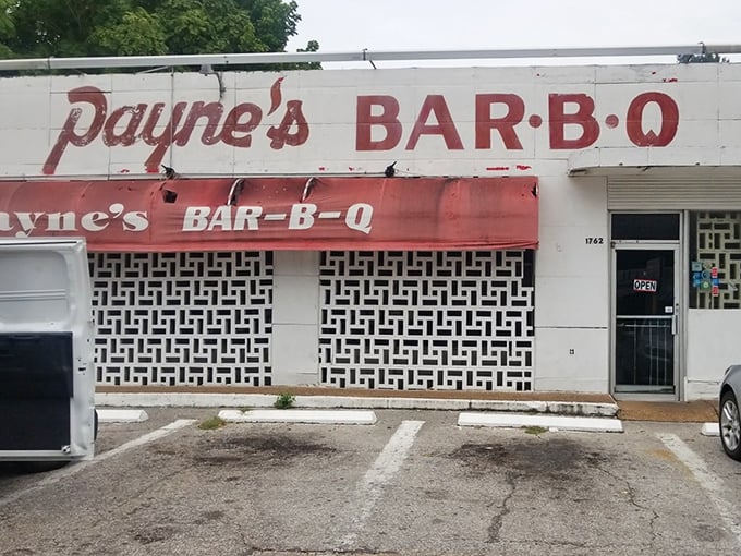The exterior might not win architectural awards, but that faded sign and red awning mark the spot where barbecue pilgrims find their holy grail.