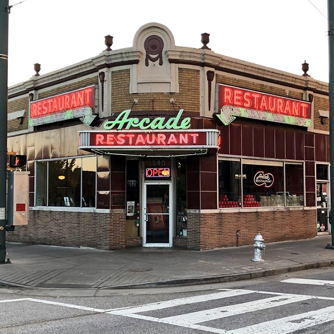 The corner entrance stands ready to welcome you like an old friend, its vintage charm unchanged while the city has transformed around it.