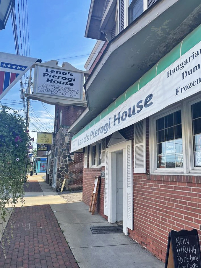 The unassuming brick exterior hides culinary treasures within. That "Now Hiring" sign means someone might get lucky enough to work in dumpling paradise.