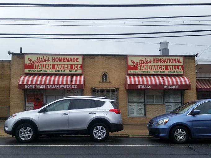 The twin awnings announce Dattilo's dual superpowers: homemade Italian water ice and sensational sandwiches. Summer in Philadelphia, perfectly captured.