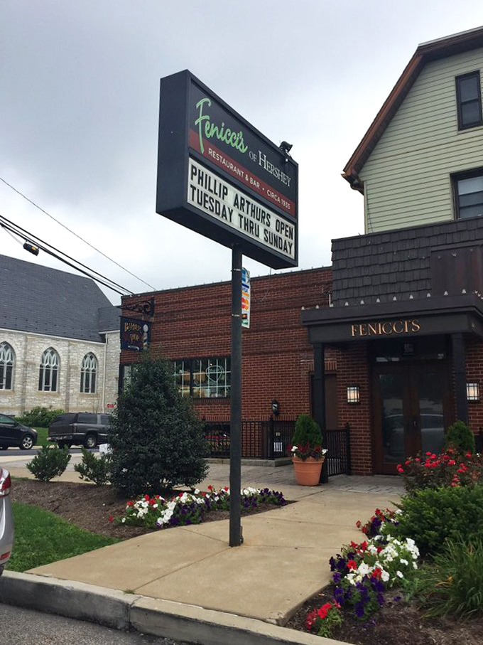 The sign stands like a beacon of hope for hungry travelers: "Abandon diet plans, all ye who enter here."