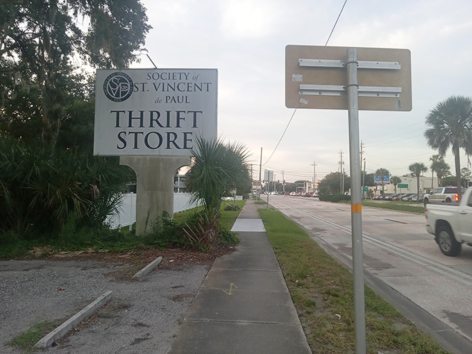 The roadside sign stands as a beacon to bargain hunters, a North Star guiding thrifty travelers to secondhand paradise.