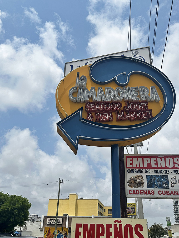 That retro sign against Miami's blue sky is like a beacon for seafood lovers. Follow the arrow to happiness, one fish sandwich at a time.