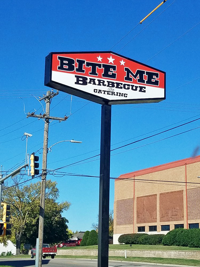 The roadside sign stands tall against the Kansas sky, a landmark more reliable than GPS. Follow it like the North Star of smoked meat.