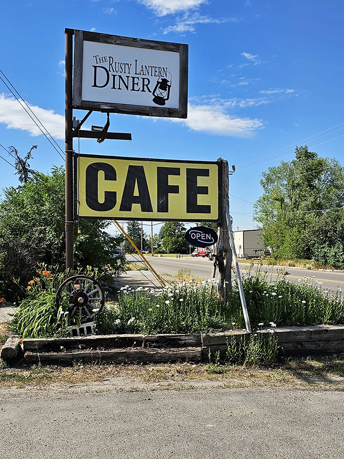 The roadside sign stands tall against Idaho's blue sky, a beacon for hungry travelers and locals alike seeking honest food without pretense.