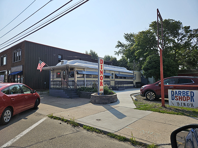 The American flag flutters gently outside this stainless steel landmark, a beacon of breakfast hope on Main Street in Lawrence Park.