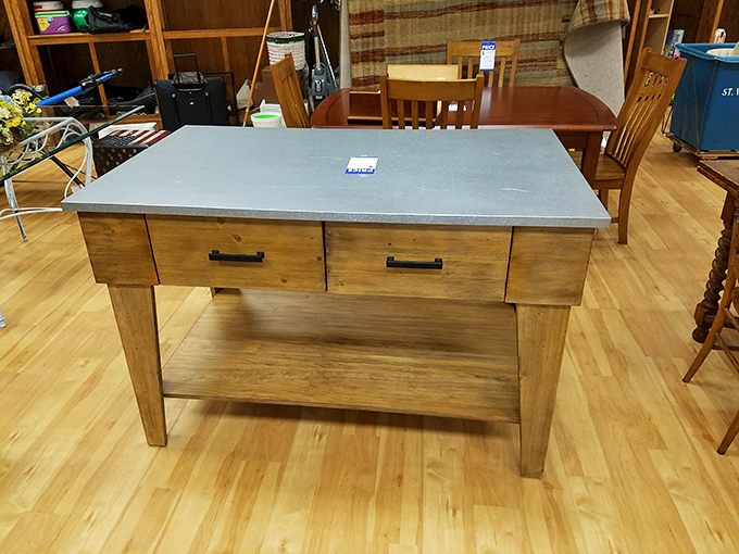 A kitchen island that combines rustic charm with practical storage. The concrete top says "serious cook" while the wooden base whispers "farmhouse chic."