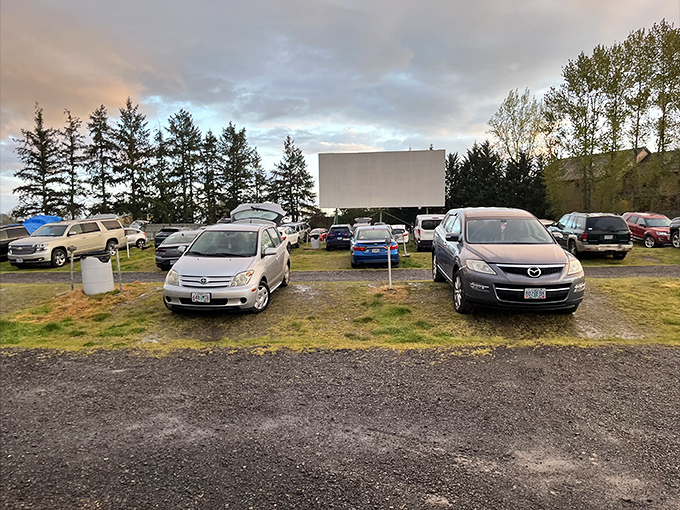 As twilight approaches, cars find their perfect viewing spots. The screen waits patiently, ready to work its rectangular magic on eager audiences.