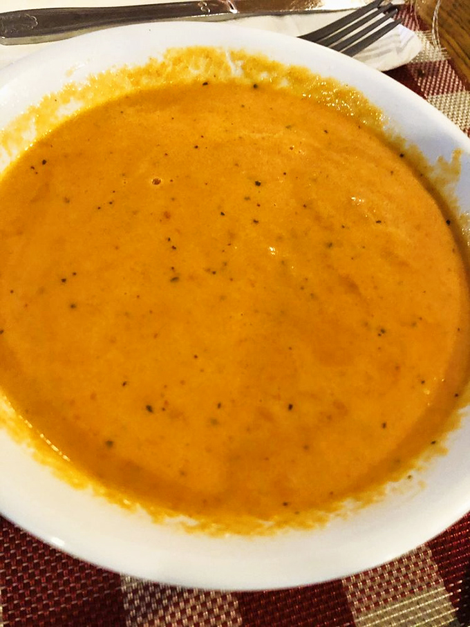 A bowl of sunshine disguised as tomato basil soup&mdash;the kind that makes you want to hug the chef and request the recipe.