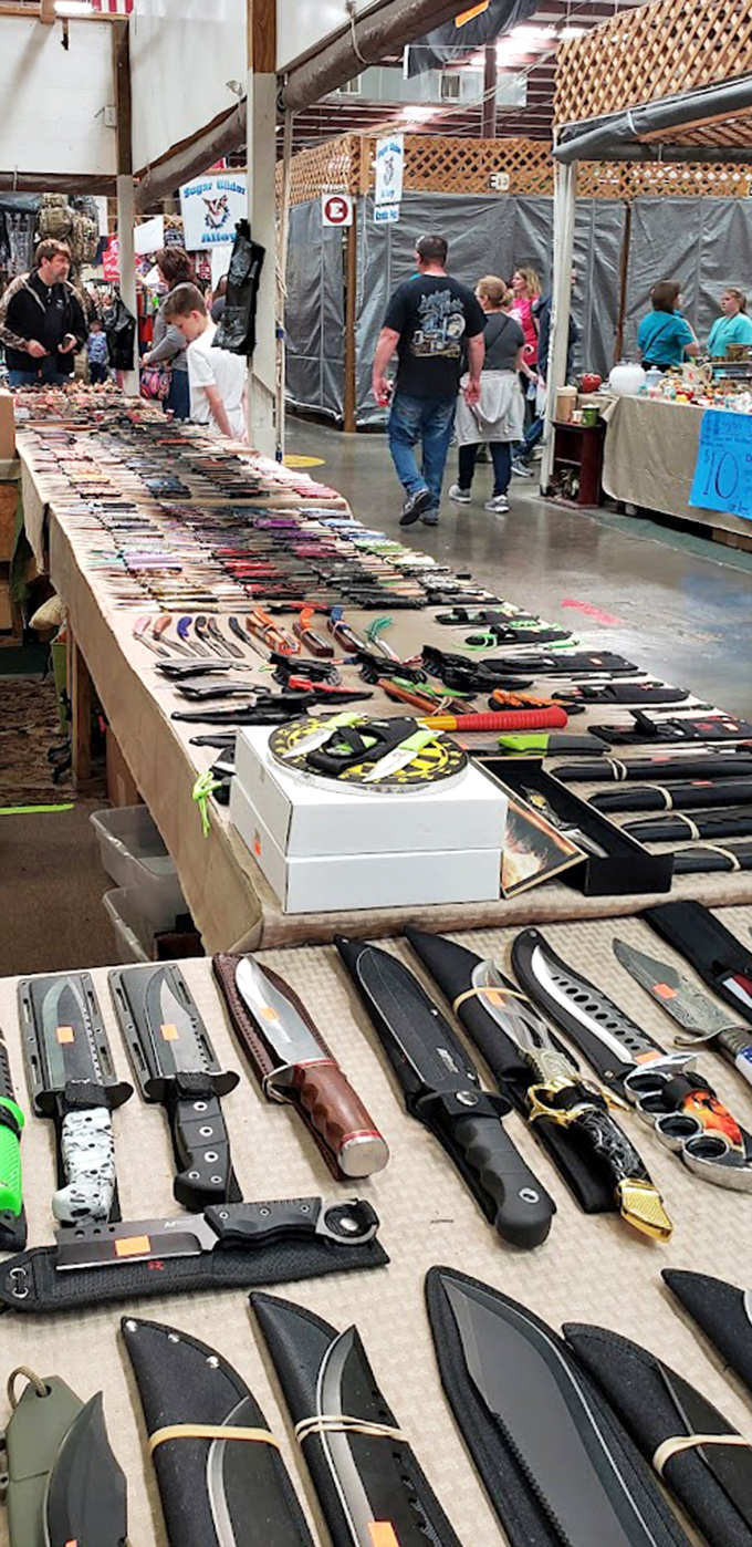 Knives spread across tables like a chef's dream catalog, each blade promising culinary adventures or camping conquests.