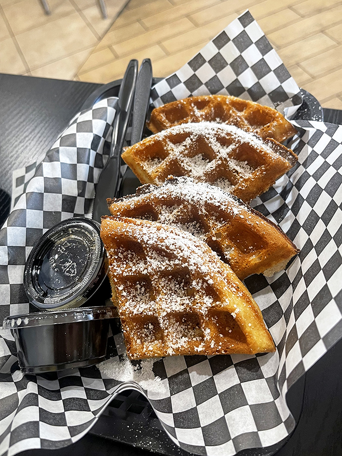 Waffles dusted with powdered sugar &ndash; the dessert you didn't know you needed after a Nashville hot chicken experience.