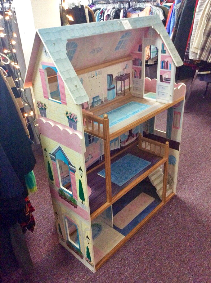 A dollhouse that's seen more careful play than most modern toys. Three stories of miniature domestic bliss waiting for its next imaginative owner.
