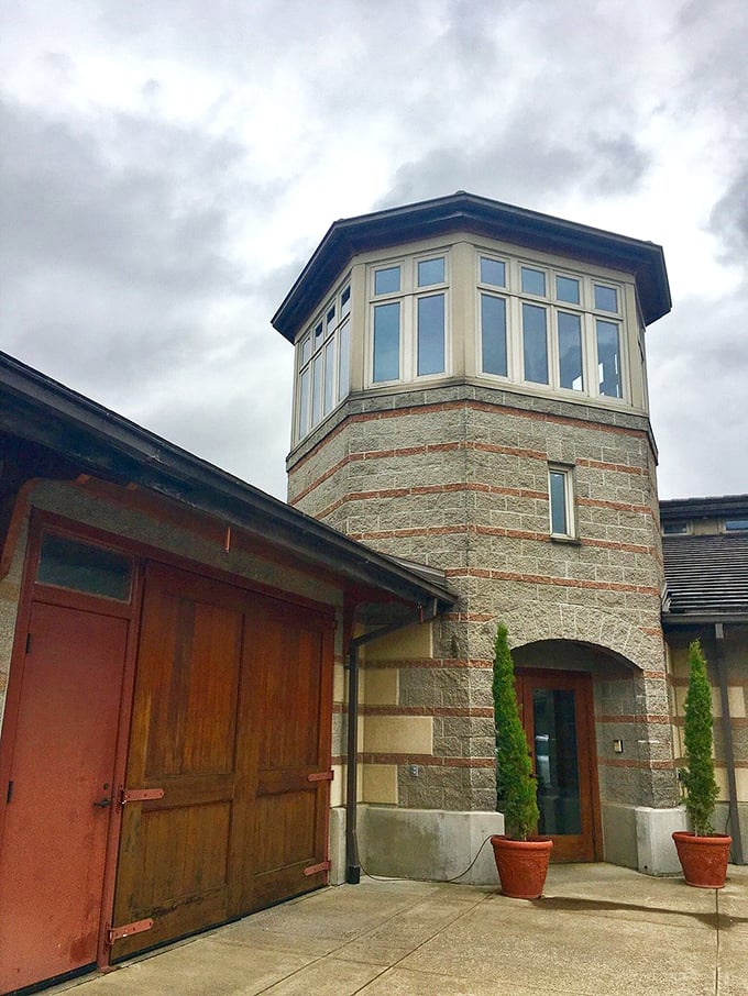 Stone tower architecture rises majestically above vineyards like a monument to Oregon winemaking excellence.