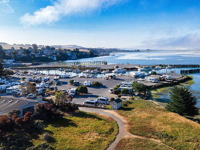 Working harbor meets natural beauty where fishing boats and RVs share views of endless Pacific.