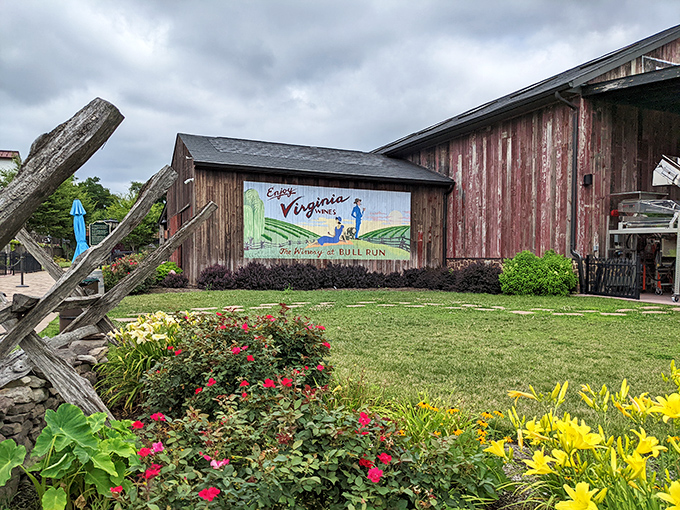 Colorful garden blooms at The Winery at Bull Run greet you beside a rustic barn featuring a vintage-style painted mural.