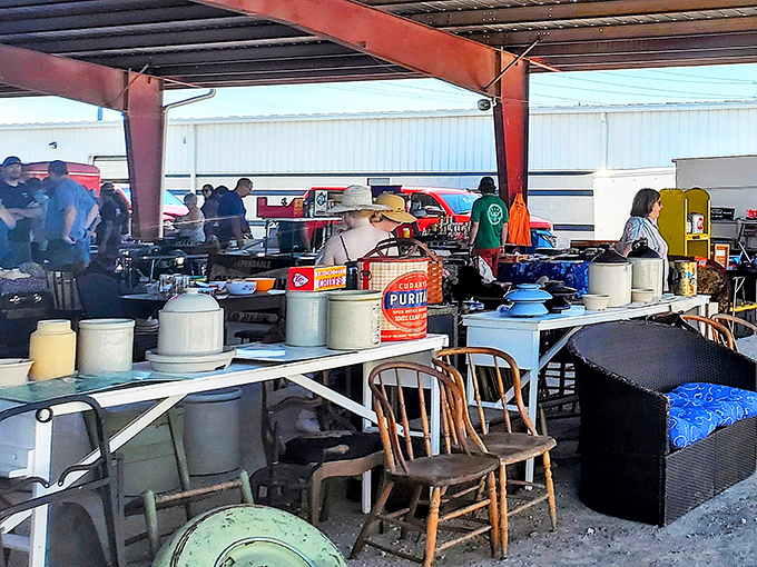 Tables overflow with treasures under protective pavilions where bargain hunters gather like bees to honey.