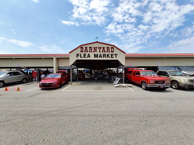 The iconic red-roofed entrance to Barnyard Flea Market beckons like a siren call to bargain hunters. Treasure awaits inside!