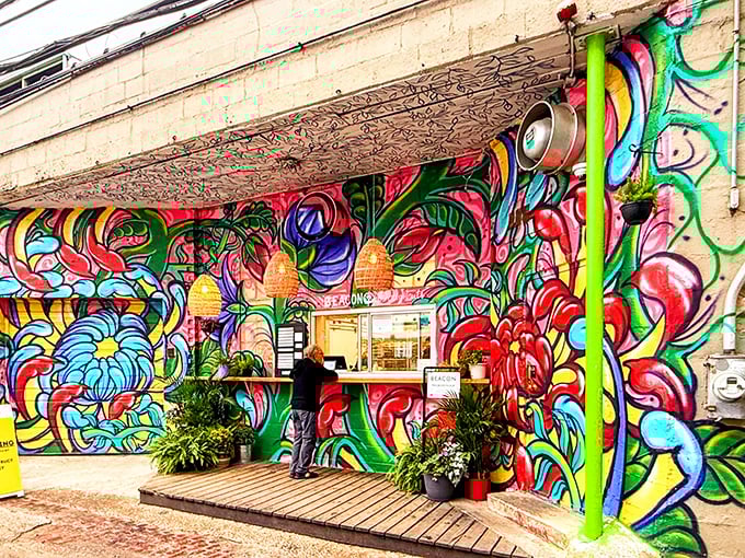 A riot of color greets donut lovers at Beacon's walk-up window. This vibrant mural makes waiting in line feel like a joyful art gallery visit!