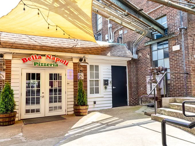 Bella Napoli's charming entrance beckons with European flair. That yellow awning promises Neapolitan magic awaits inside.