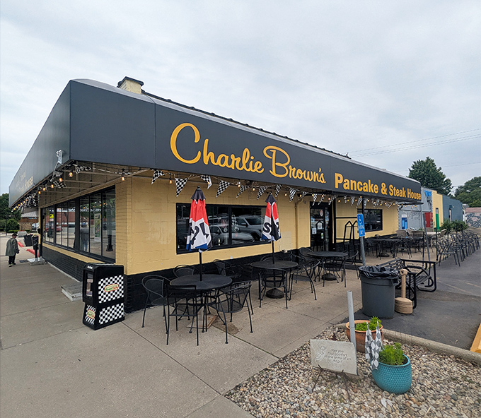 Racing flags and outdoor seating signal serious breakfast business - Charlie Browns knows comfort starts before you walk in.