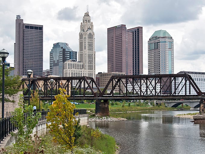 Columbus skyline rises like a gentle giant, where the Scioto River whispers stories of Midwestern dreams.