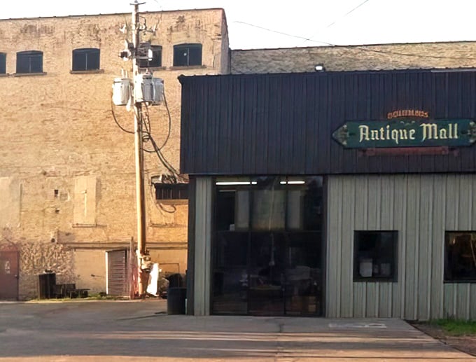 The unassuming facade of Columbus Antique Mall - where treasures hide behind blue signage like Narnia behind a wardrobe.