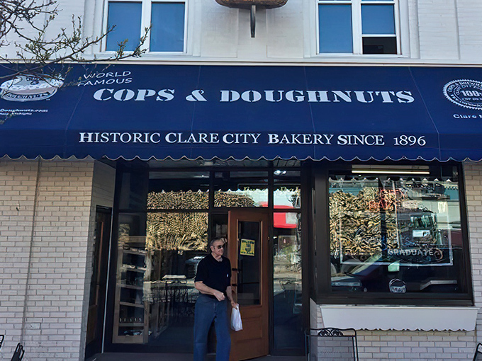 The iconic blue awning of Cops & Doughnuts beckons like a sweet siren call to donut lovers across Michigan.