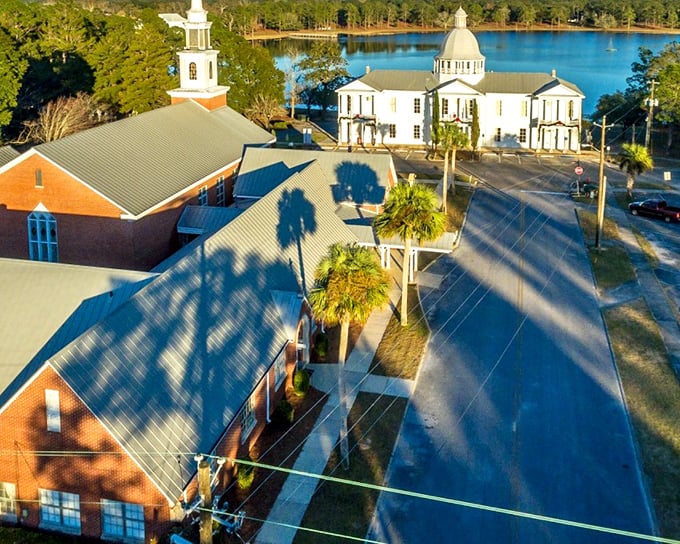 DeFuniak Springs' Victorian houses gather around that perfectly round lake like elegant guests at a garden party.