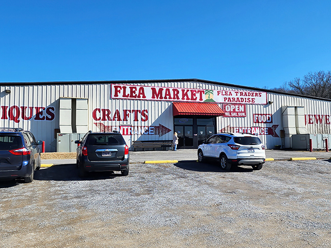 That bright red "FLEA MARKET" sign promises treasures inside like a beacon for bargain hunters everywhere.