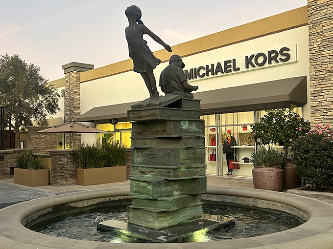 That fountain statue looks ready to help you carry all those shopping bags you're about to collect!