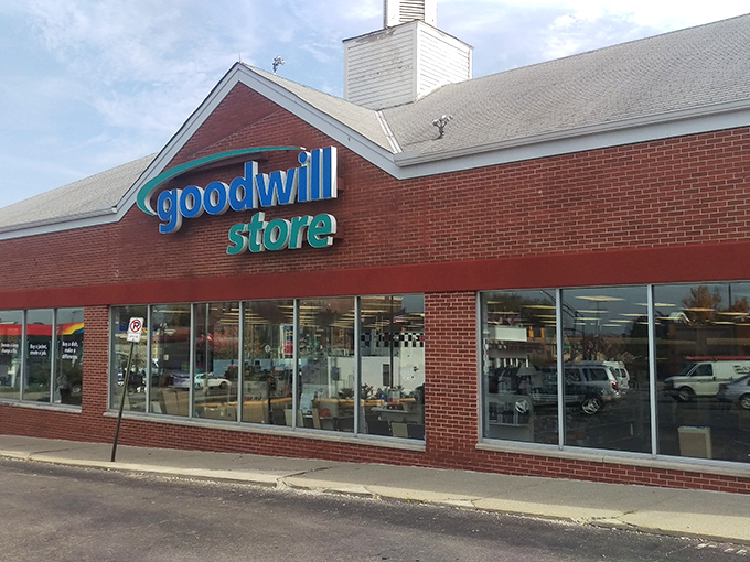 The iconic blue Goodwill sign beckons bargain hunters like a lighthouse for the thrifty. Inside awaits a treasure trove of possibilities.