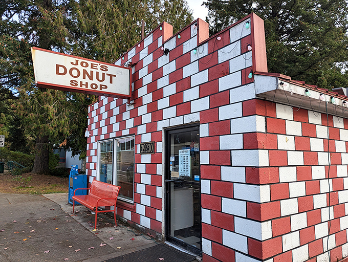 Joe's Donut Shop's iconic red and white checkered exterior stands out like a delicious mirage on the road to Mt. Hood. The small building with its vintage sign promises sweet treasures inside.
