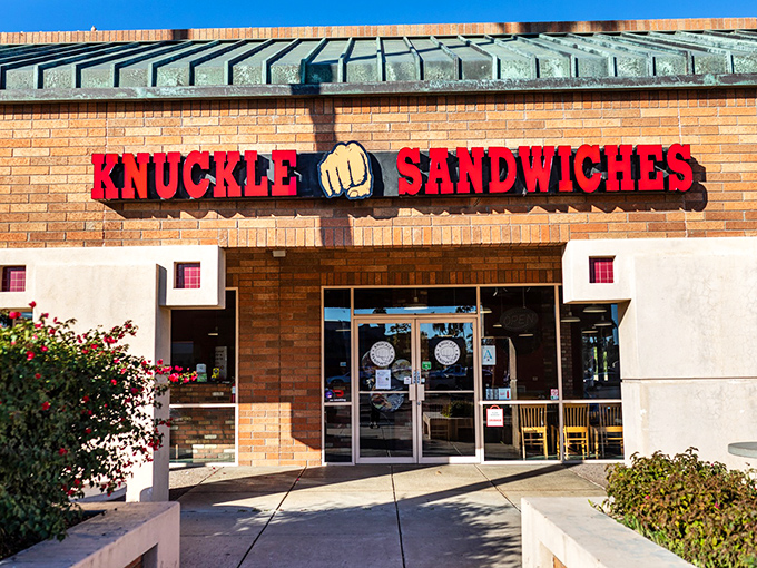 That red fist logo means business - this Mesa strip mall hides sandwich magic behind unassuming brick walls.