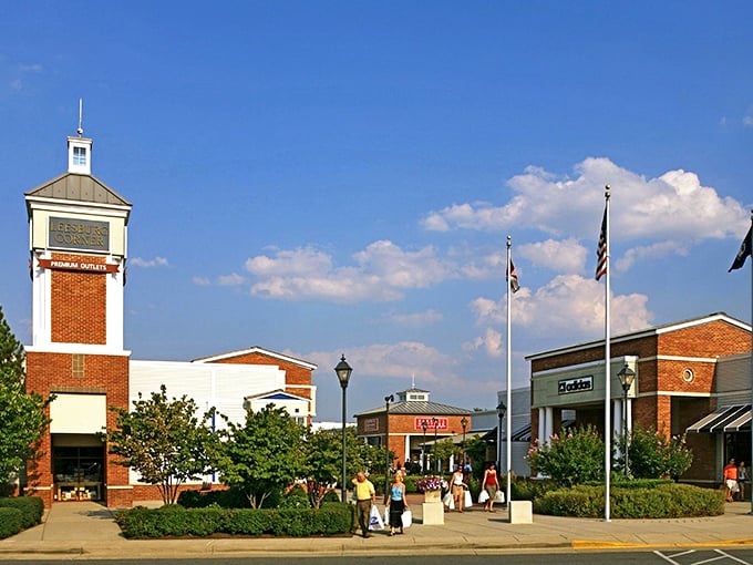 The iconic clock tower at Leesburg Corner Premium Outlets stands tall against blue skies, welcoming bargain hunters to shopping paradise.