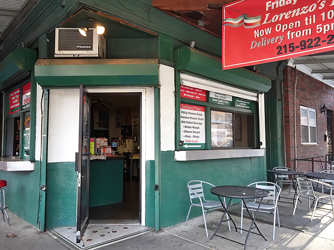 The unassuming green exterior of Lorenzo's hides pizza magic within &ndash; like finding a treasure chest disguised as a garden shed.
