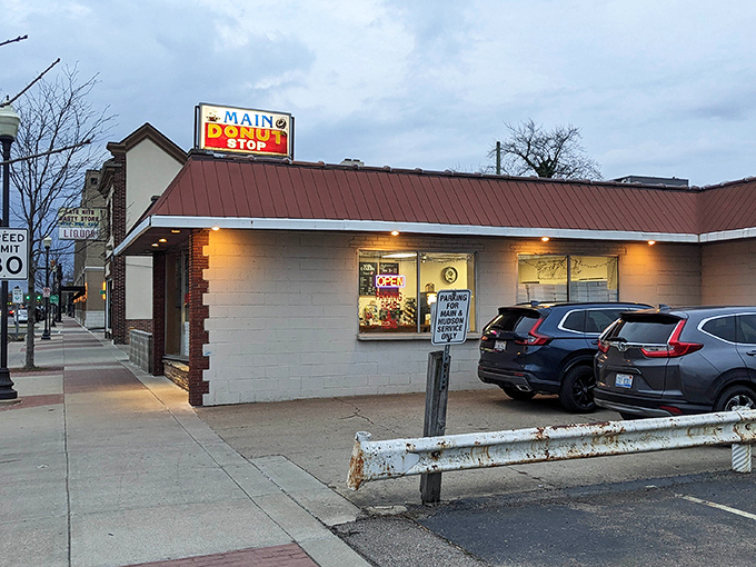 That classic brick and metal exterior whispers "authentic donuts inside" louder than any fancy neon sign ever could.
