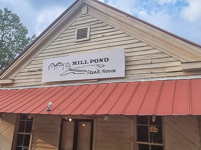 That red roof and rustic charm whisper "serious steak ahead" &ndash; Mill Pond knows presentation matters.