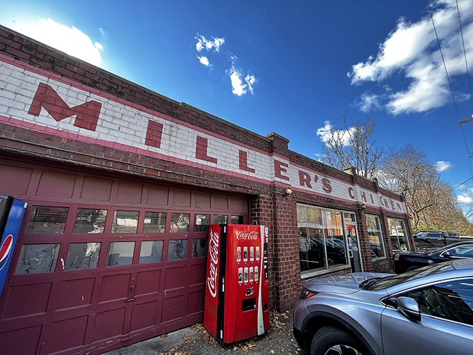 Miller's Chicken sits like a red-brick beacon of comfort, promising golden treasures within those weathered walls.