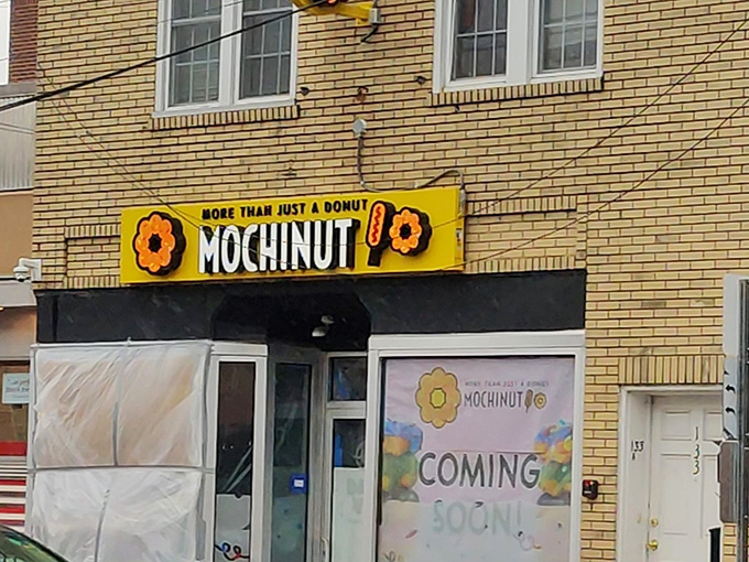 That yellow sign promises more than just donuts &ndash; it's a passport to chewy, stretchy happiness that defies physics.