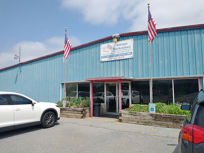 The bright blue exterior of Old Glory Antique Marketplace stands like a beacon for treasure hunters. American flags proudly announce this is no ordinary shopping trip!