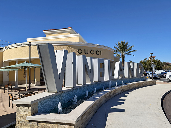 The iconic Vineland sign welcomes shoppers like a retail Statue of Liberty. Gucci in the background whispers, "Your credit card is about to have an adventure."