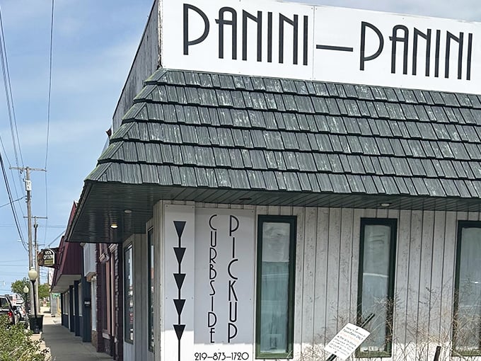 The iconic Panini Panini sign beckons sandwich lovers like a pressed-bread lighthouse on Michigan City's culinary shore.