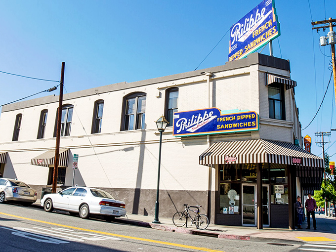 That classic neon sign beckoning like a lighthouse for hungry souls seeking the original French dip experience.