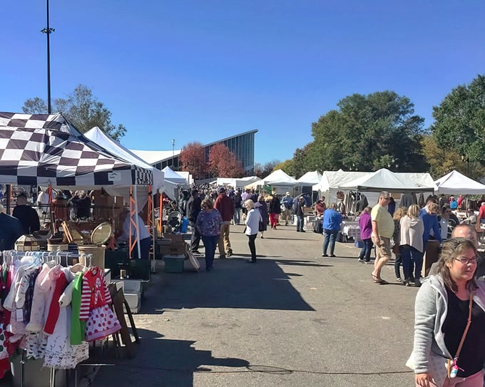 Treasure hunters navigate a sea of colorful tents at Raleigh's State Fairgrounds. That checkered canopy might hide your next conversation piece!