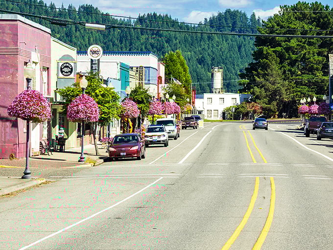 Main Street magic unfolds where colorful storefronts meet mountain backdrops in perfect small-town harmony.